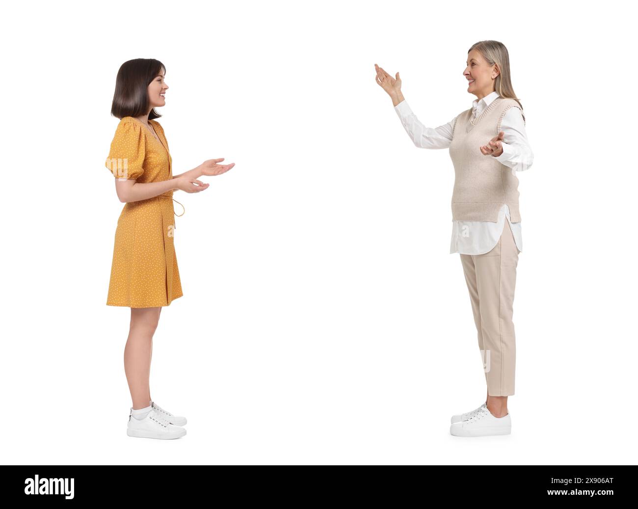 Two women talking on white background. Dialogue Stock Photo - Alamy