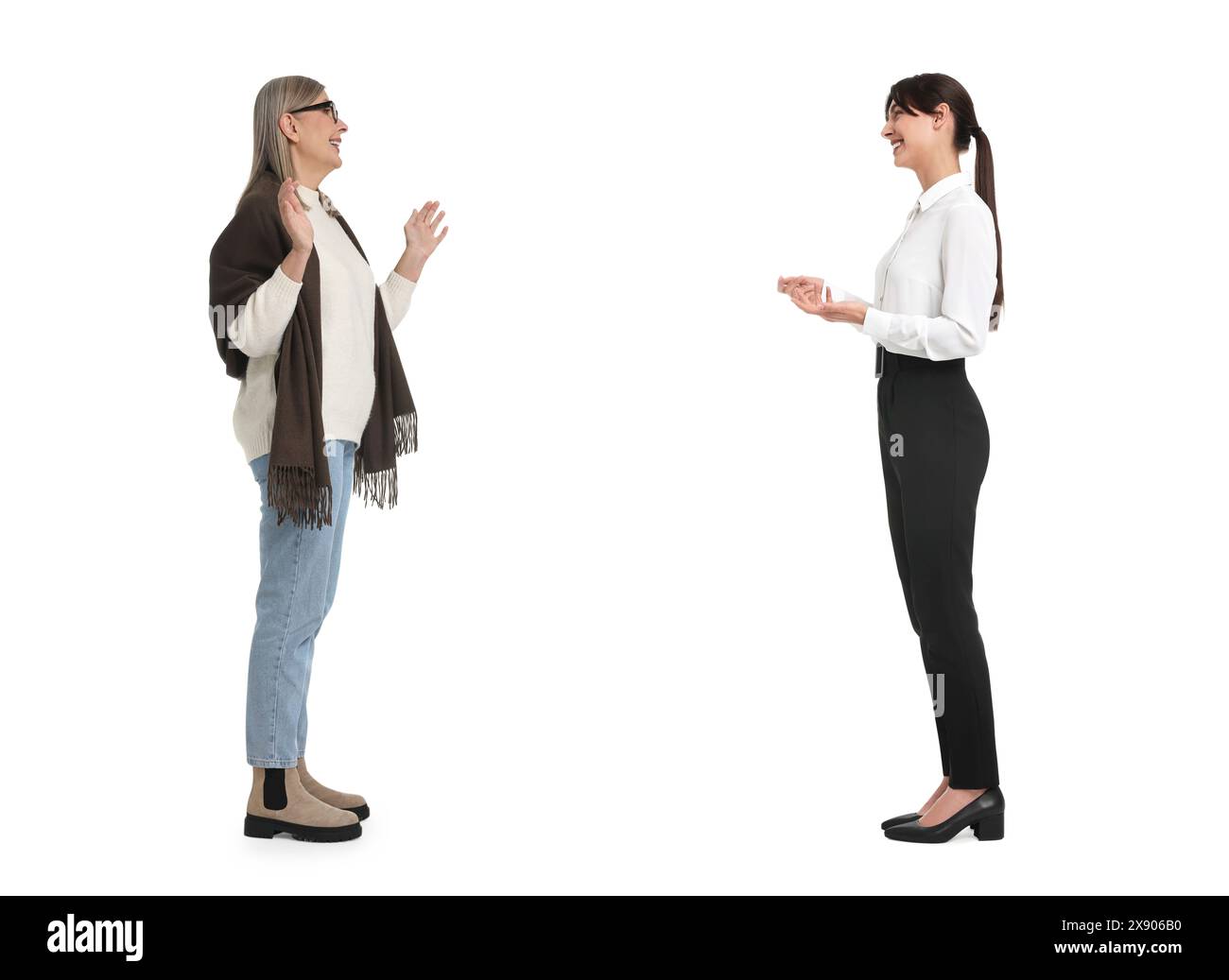 Two women talking on white background. Dialogue Stock Photo - Alamy