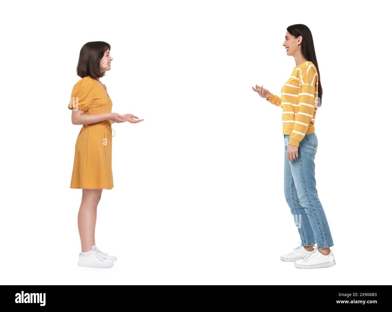 Two women talking on white background. Dialogue Stock Photo - Alamy
