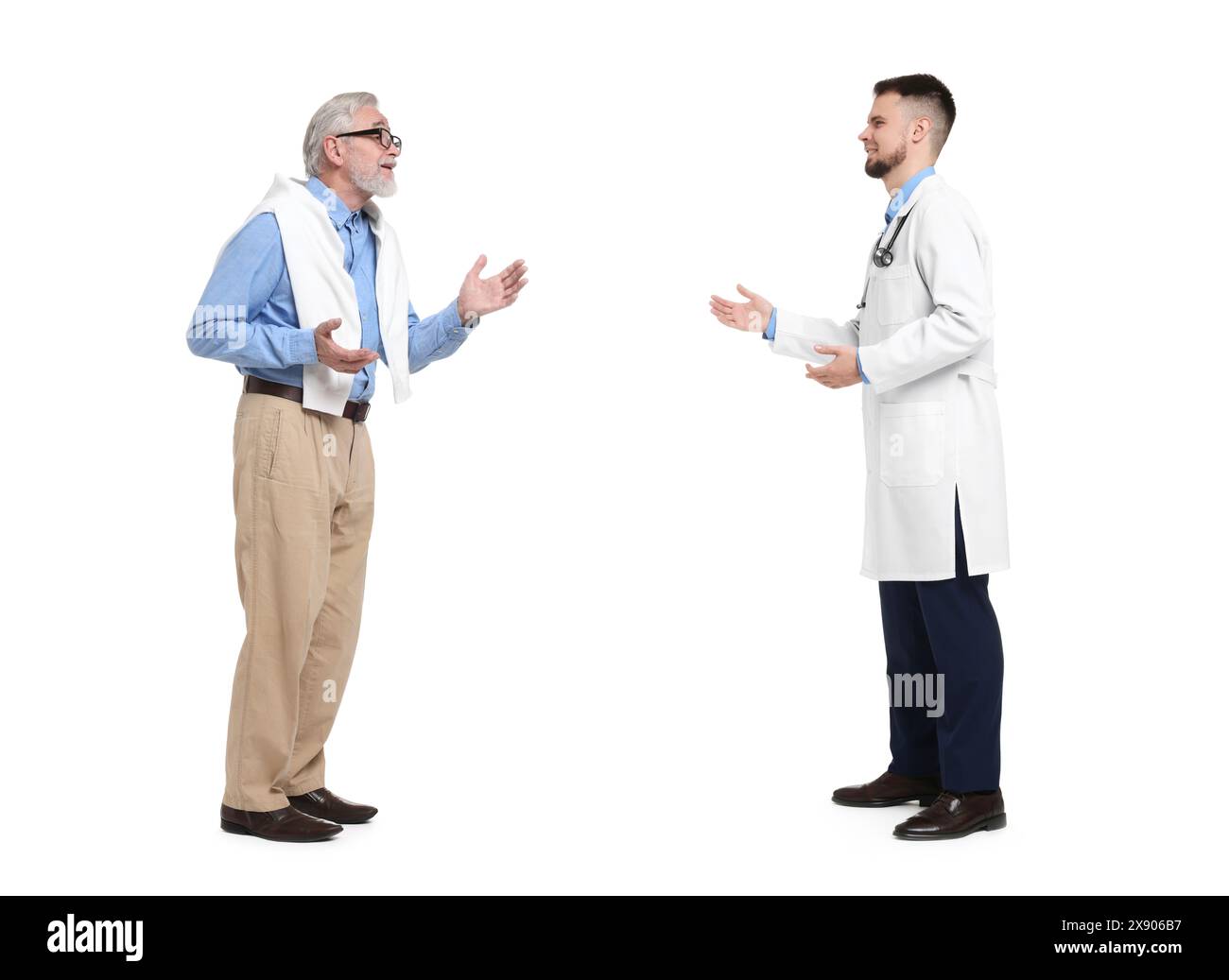 Doctor and senior man talking on white background. Dialogue Stock Photo ...