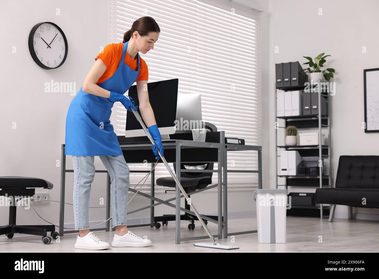 Cleaning service. Woman washing floor with mop in office Stock Photo ...