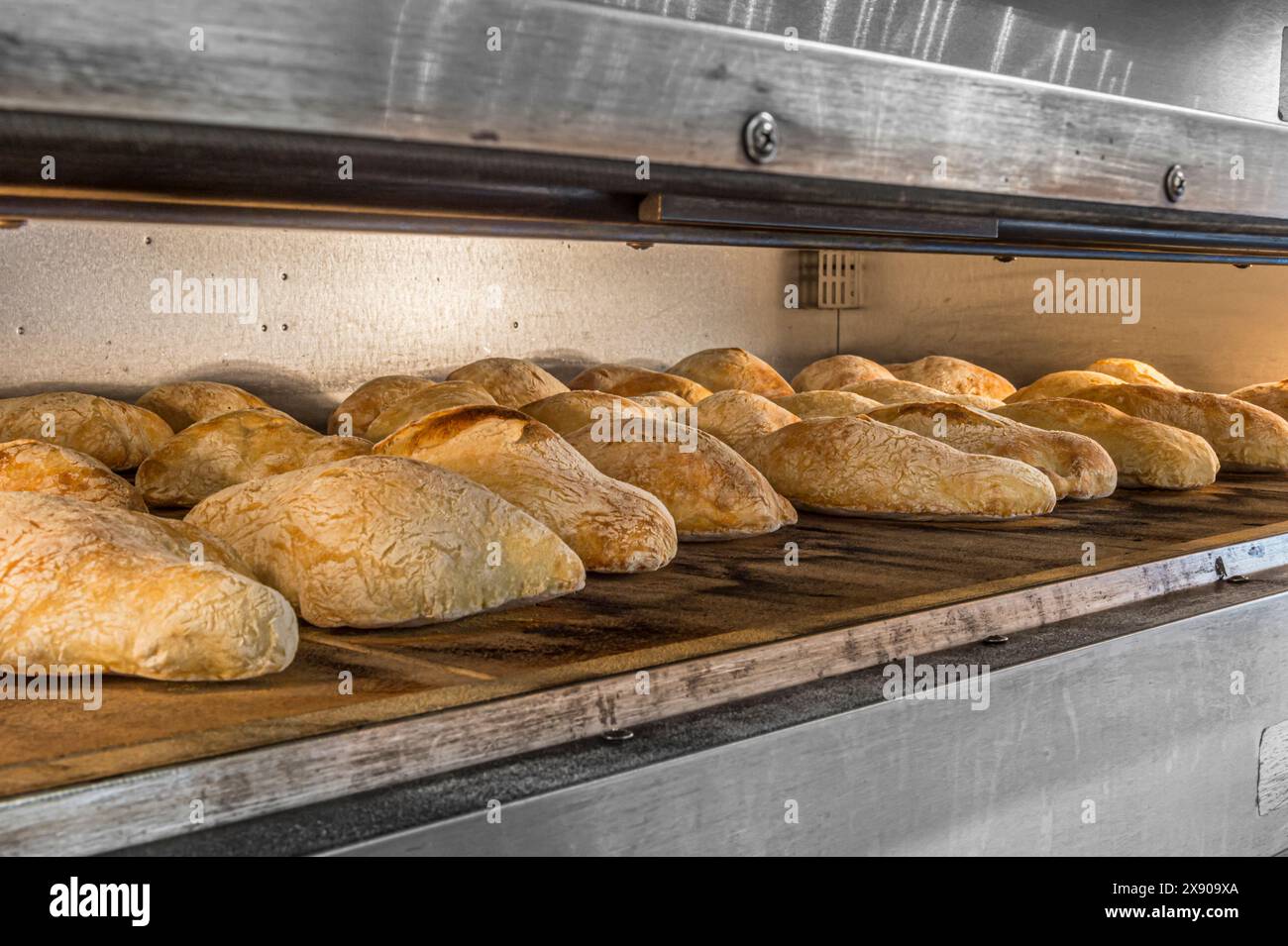 Many loaves of bread baking in oven Stock Photo - Alamy
