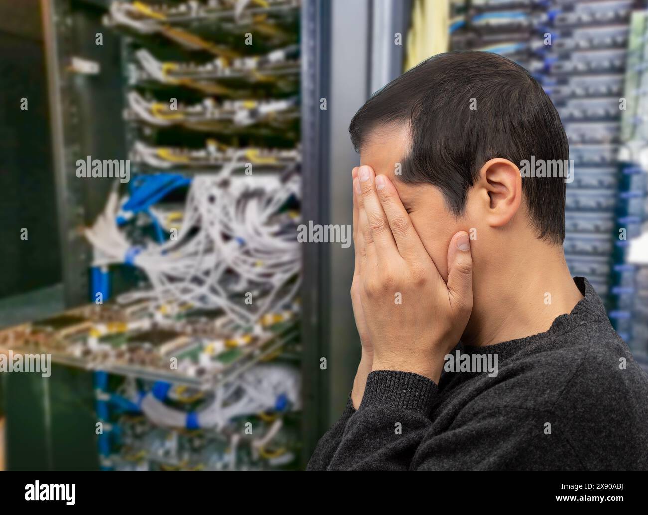 Profile shot of an IT technician having difficulty repairing a computer ...