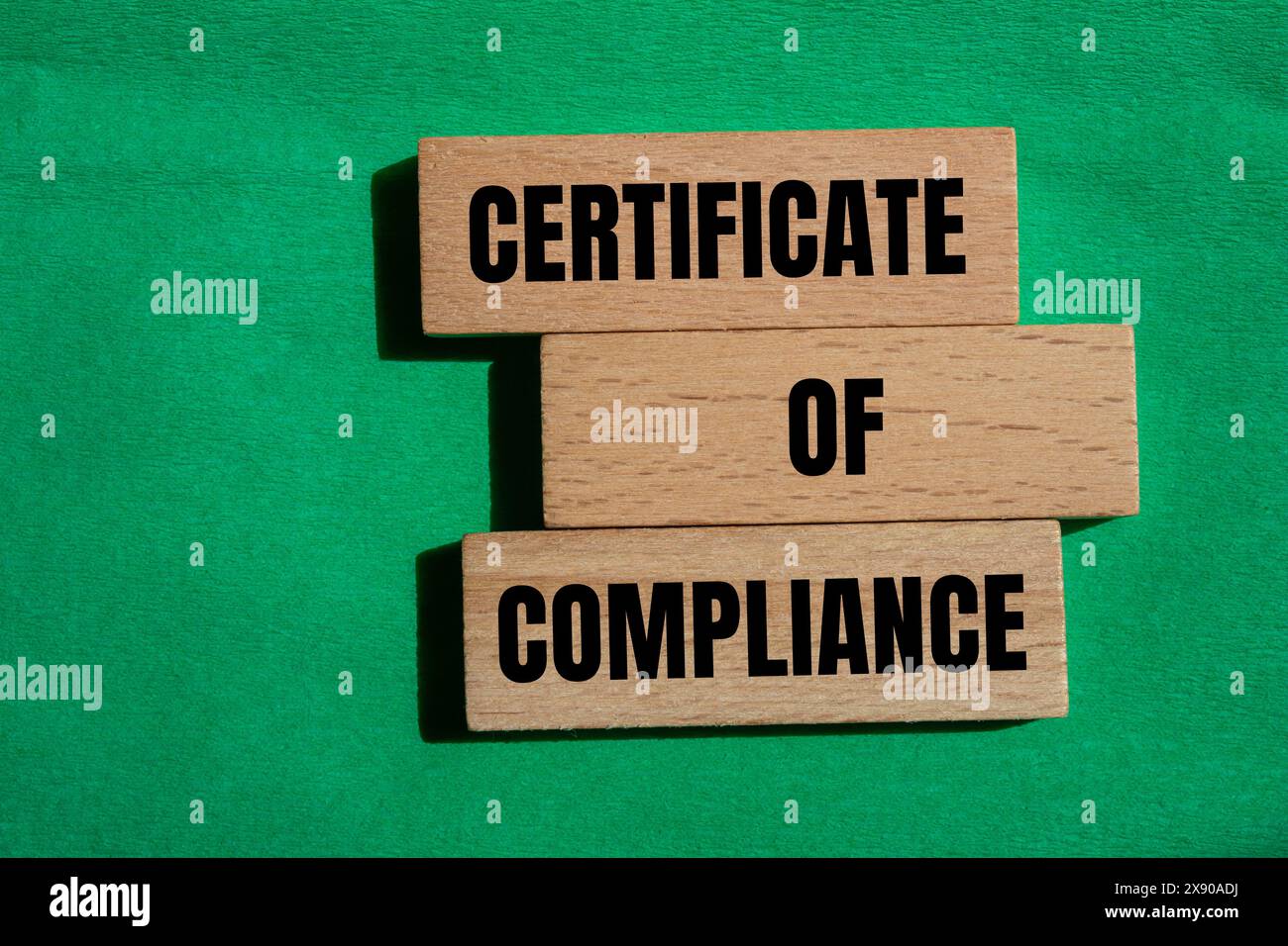 Certificate of compliance words written on wooden blocks with green ...