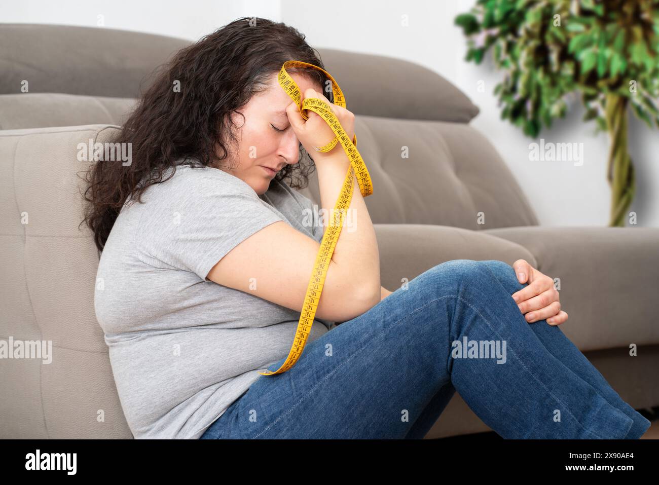 Profile of a sad woman obsessed with diet complaining sitting in couch ...