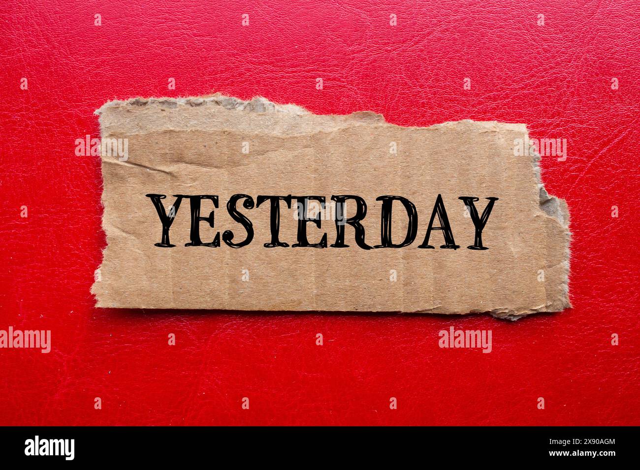 Yesterday word written on ripped cardboard paper piece with red ...