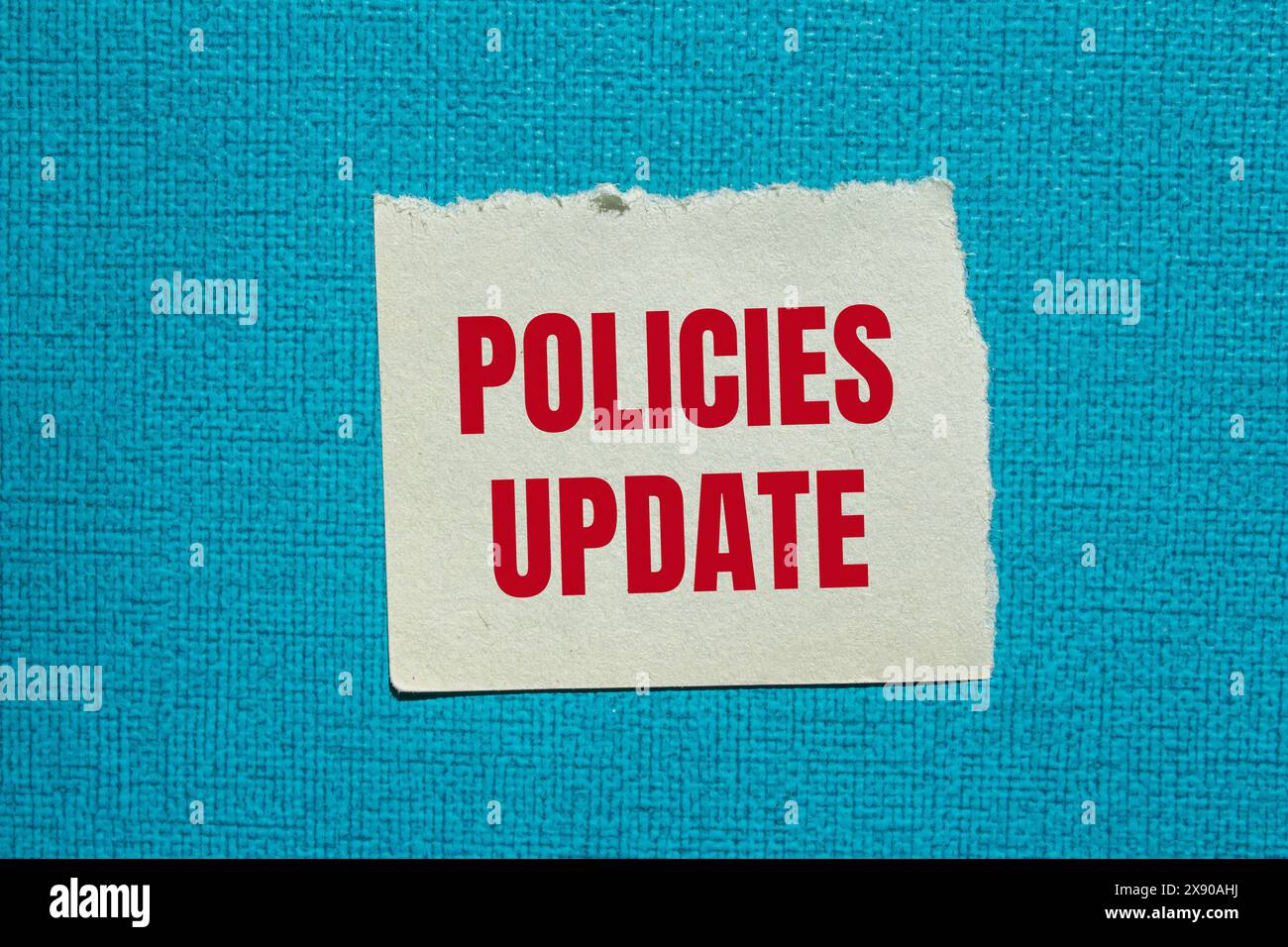 Policies update words written on ripped paper with blue background. Conceptual policies update ...