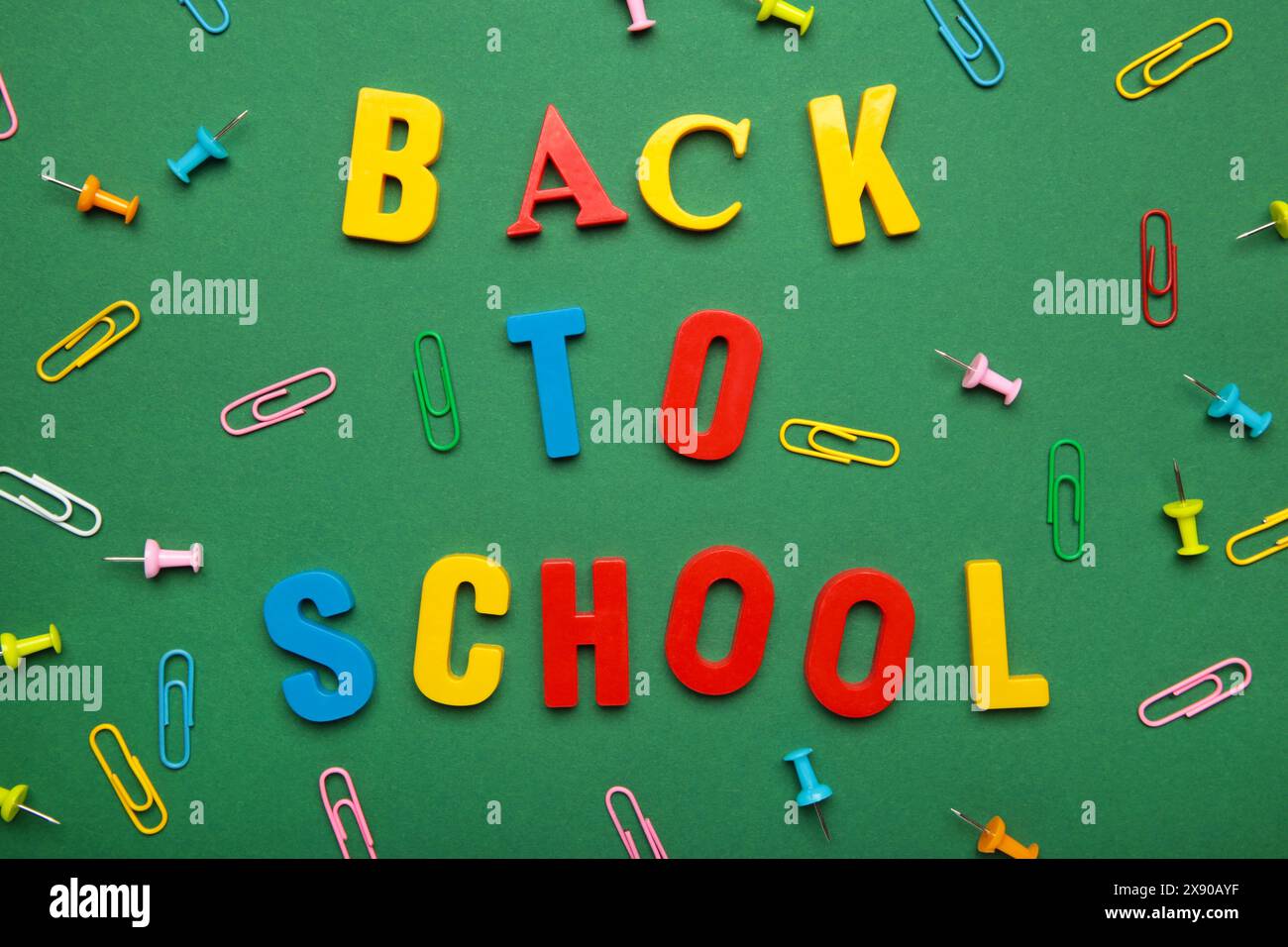 Back to School alphabet letters with school supplies on green ...
