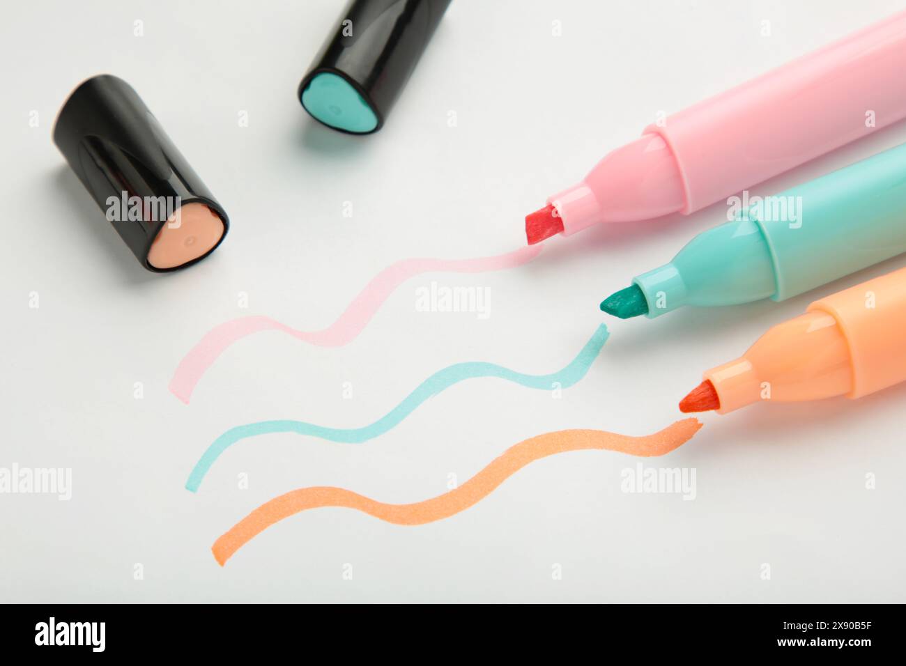 Text markers and painted waves on white. Top view Stock Photo - Alamy