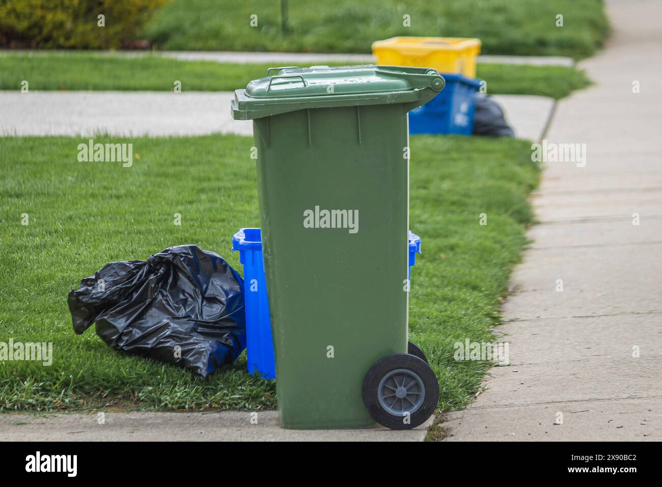 garbage, recycle and waste bins at curb side for garbage pick up day in ...