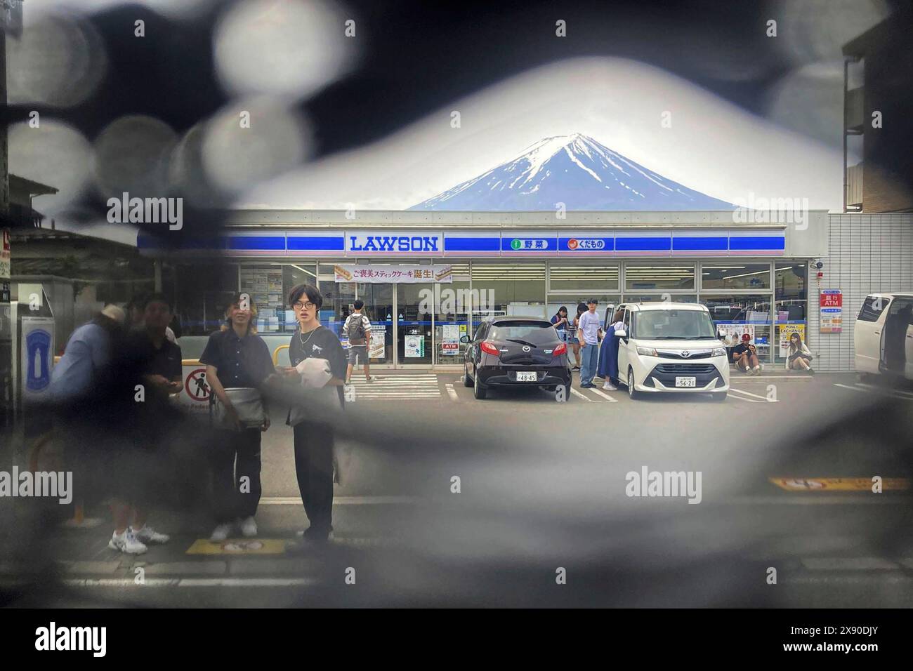 Mt. Fuji is seen through a hole on a black screen installed across from ...