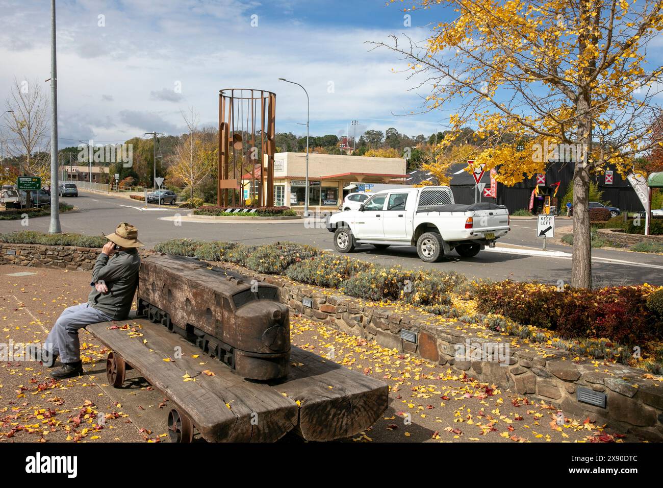 Walcha twon centre australian mat in hat talks on phone sitting on ...