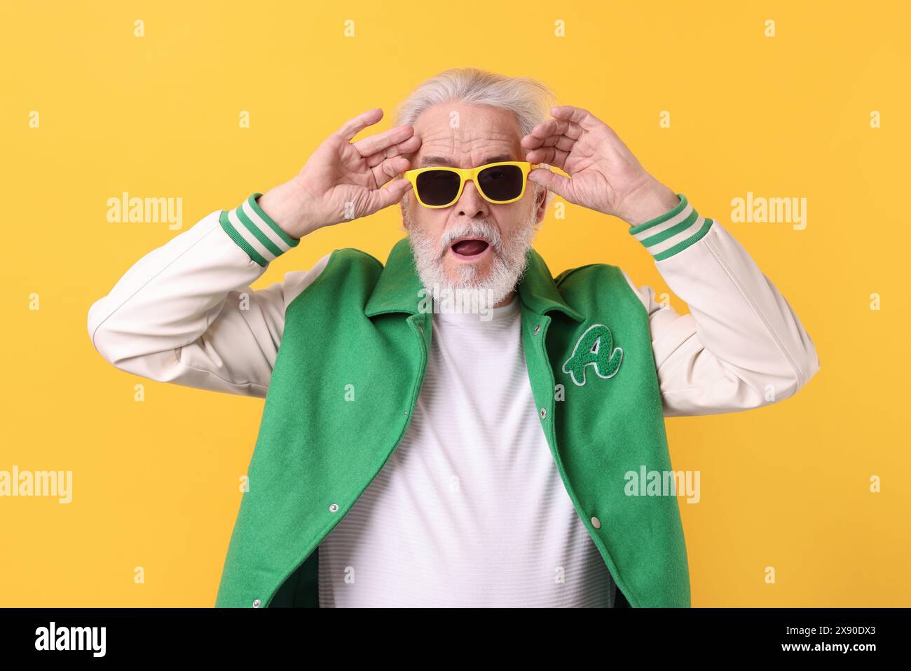 Portrait of grandpa with stylish sunglasses on yellow background Stock ...