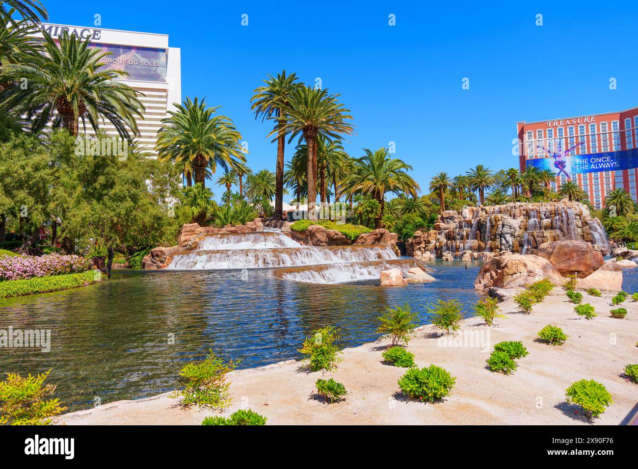 Las Vegas, Nevada - April 13, 2024: Palm Trees and Waterfall in Front of the Mirage and Treasure ...