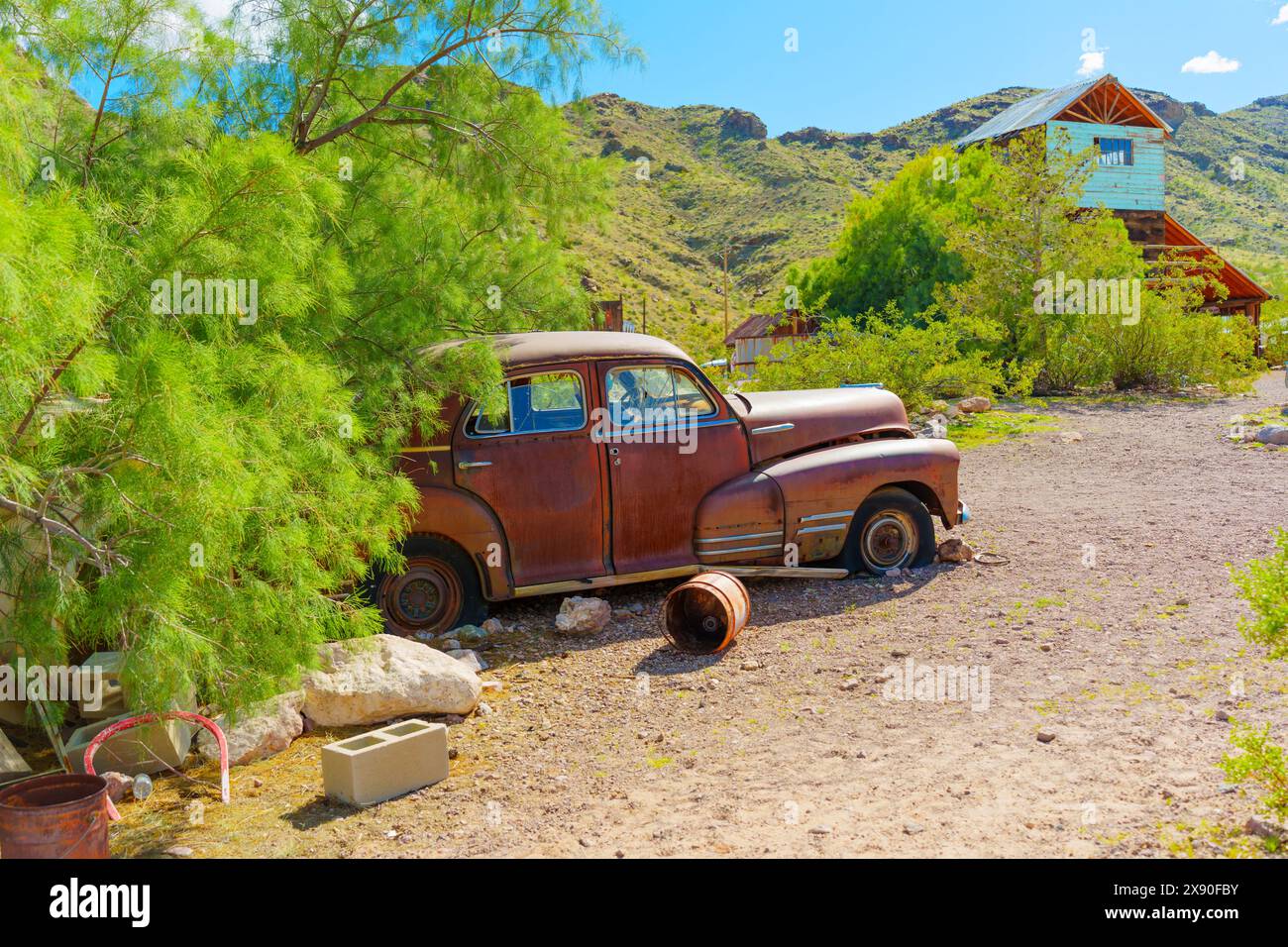 Nelson, Nevada - April 15, 2024: Antique rusted car stands alone in an abandoned Wild West ...