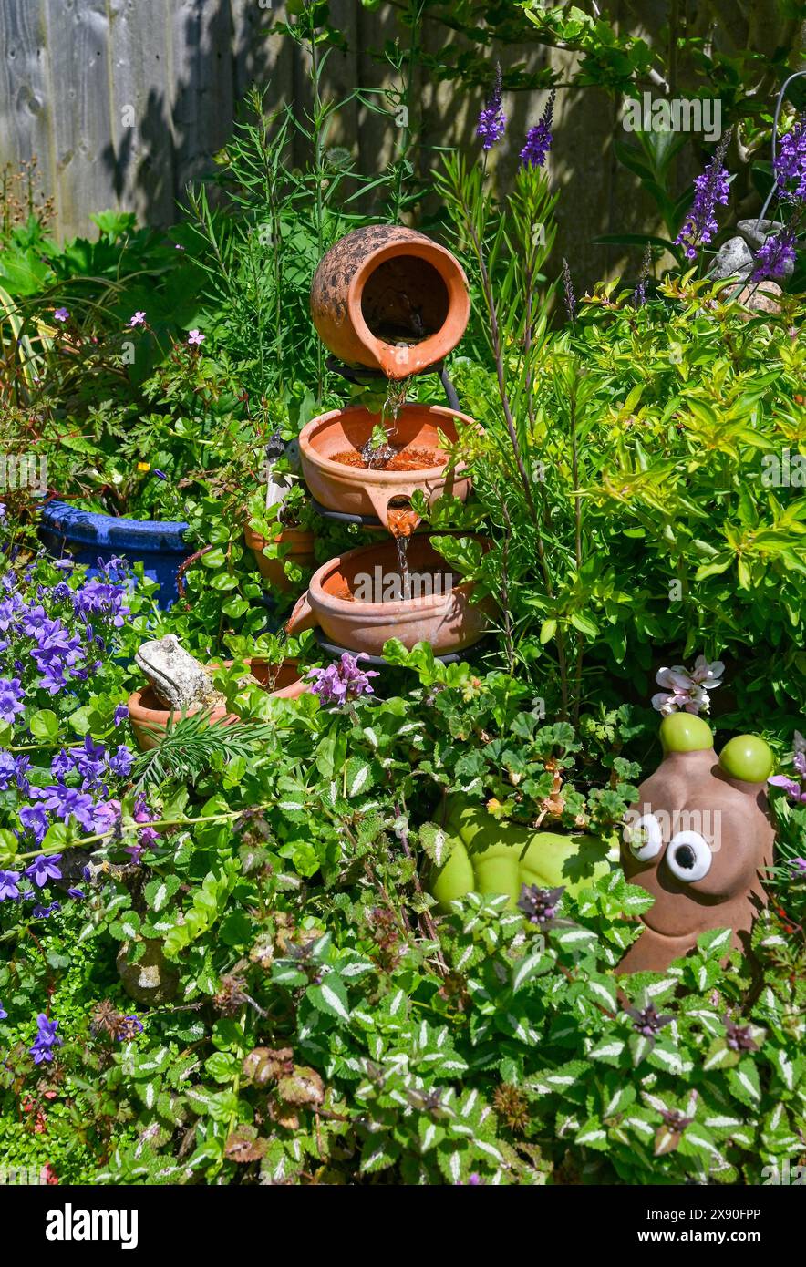 Small solar powered water feature in an urban city garden Stock Photo ...