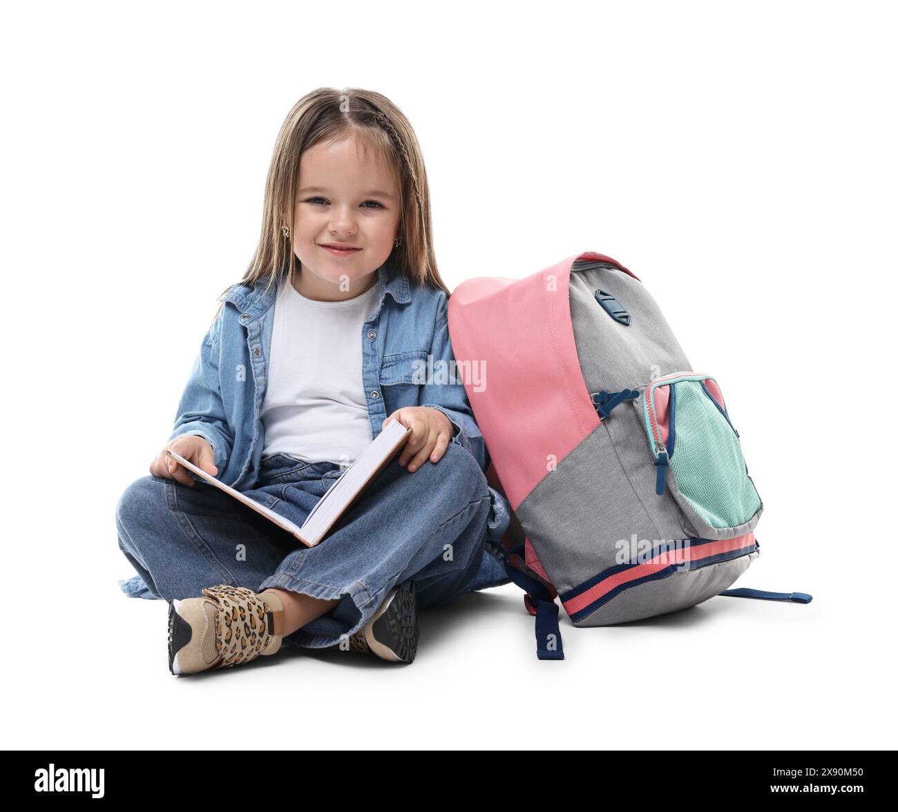 Cute little girl with book and backpack on white background Stock Photo ...