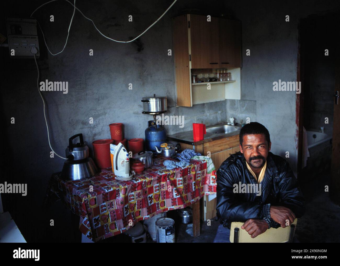 Cape Town townships. mid 1990s. Man in his newly built RDP house (post ...