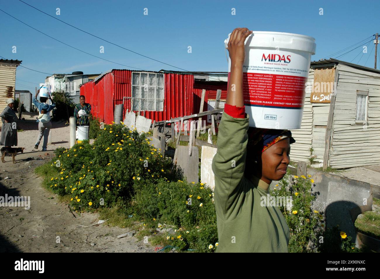 Communal (shared) water taps, Phillippi township. Woman carrying water ...