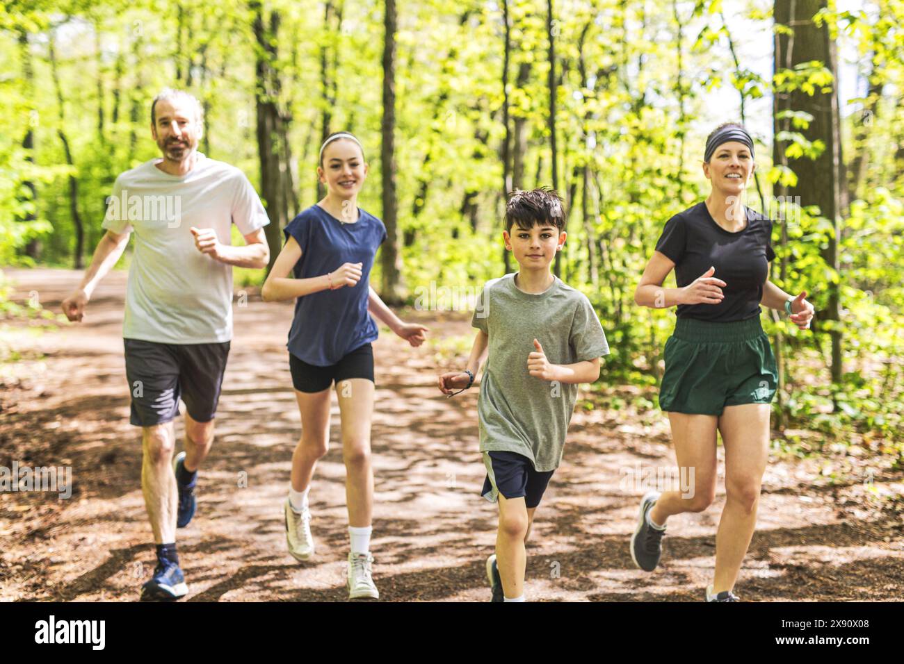 A Family exercising and jogging together at an outdoor park having ...