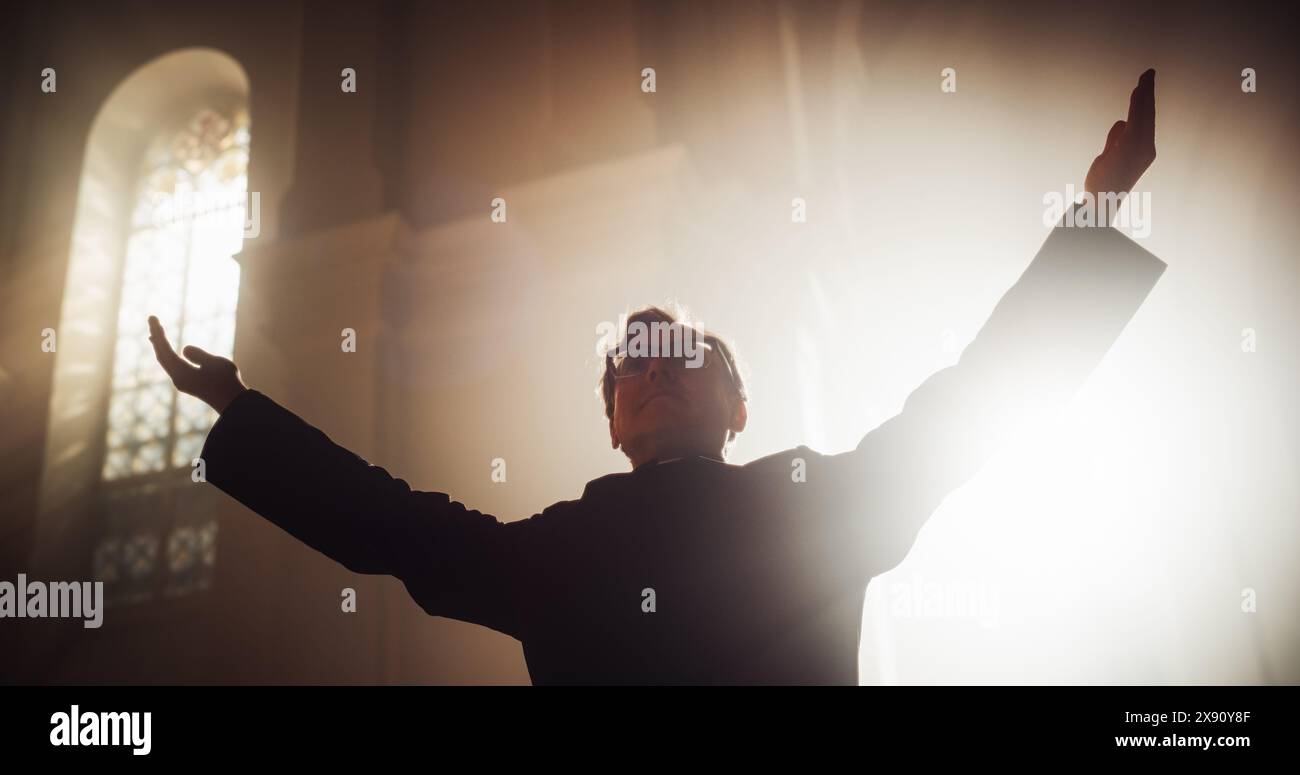 Portrait of Christian Priest Raising Hands In Blessing His Congregation ...