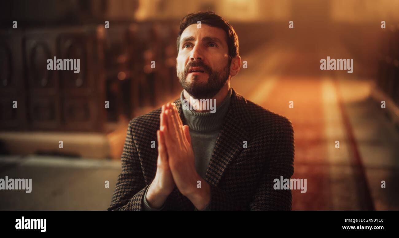 Young Christian Man on his Knees in Church, with Folded Hands. Praying ...
