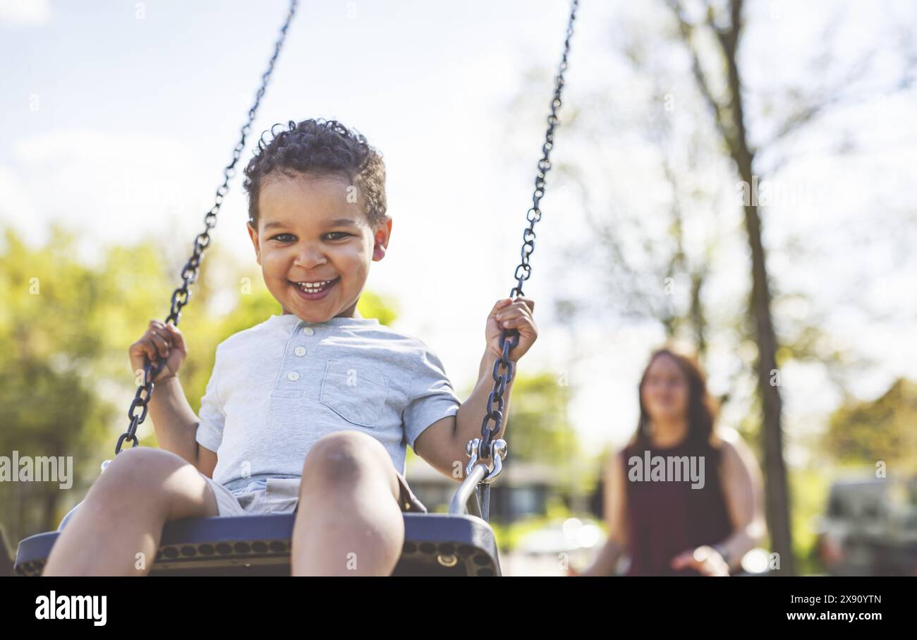 Playtime Moments. Mom With Her son Swinging Having Fun on the ...