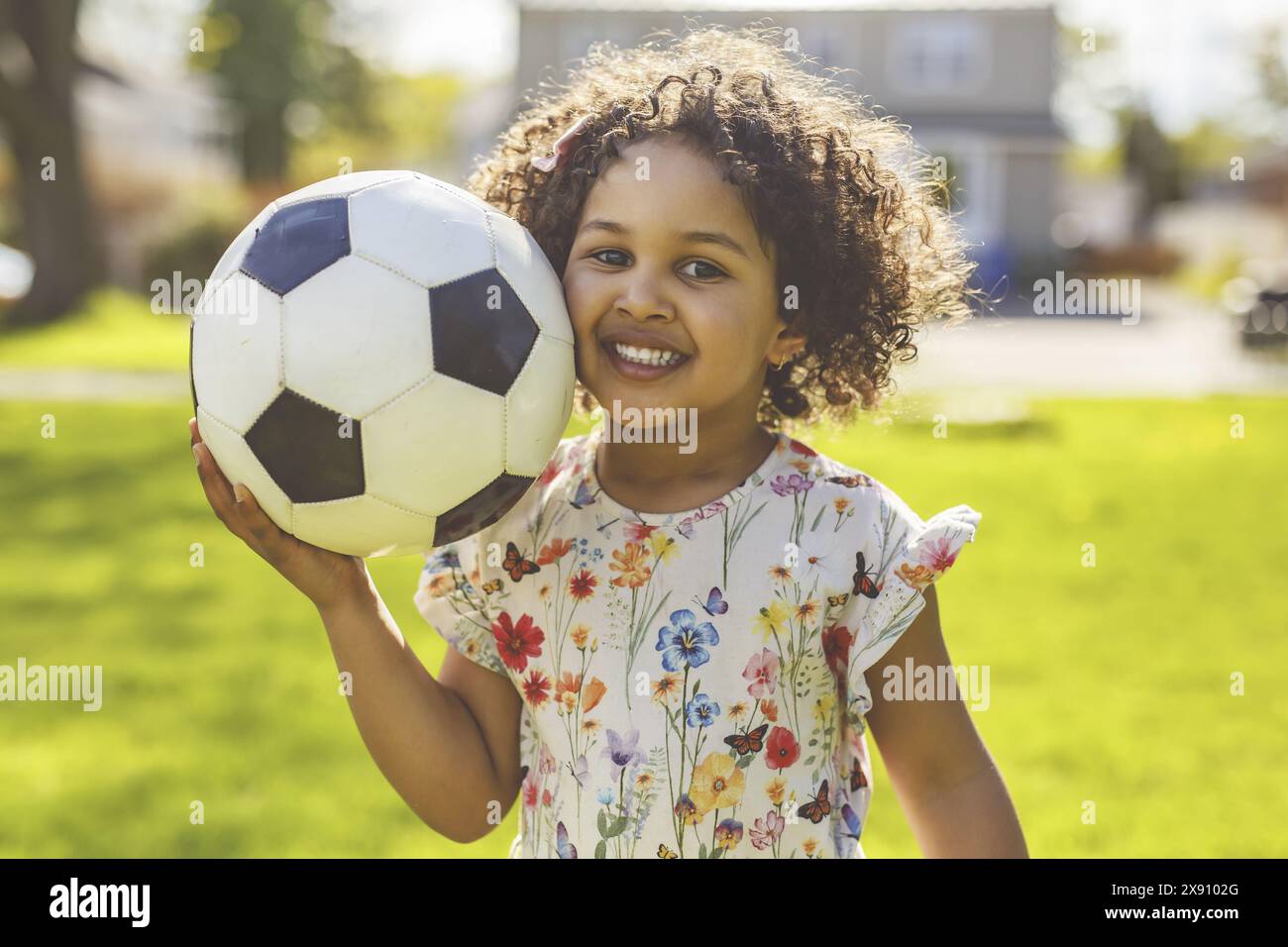 Sports kid. Happy little girl kid with a soccer ball, Child plays Stock ...