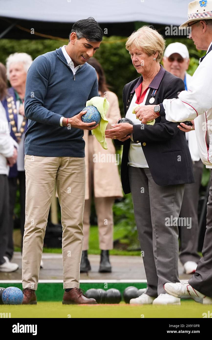 Prime Minister Rishi Sunak polish's his bowl, as he plays a game of ...