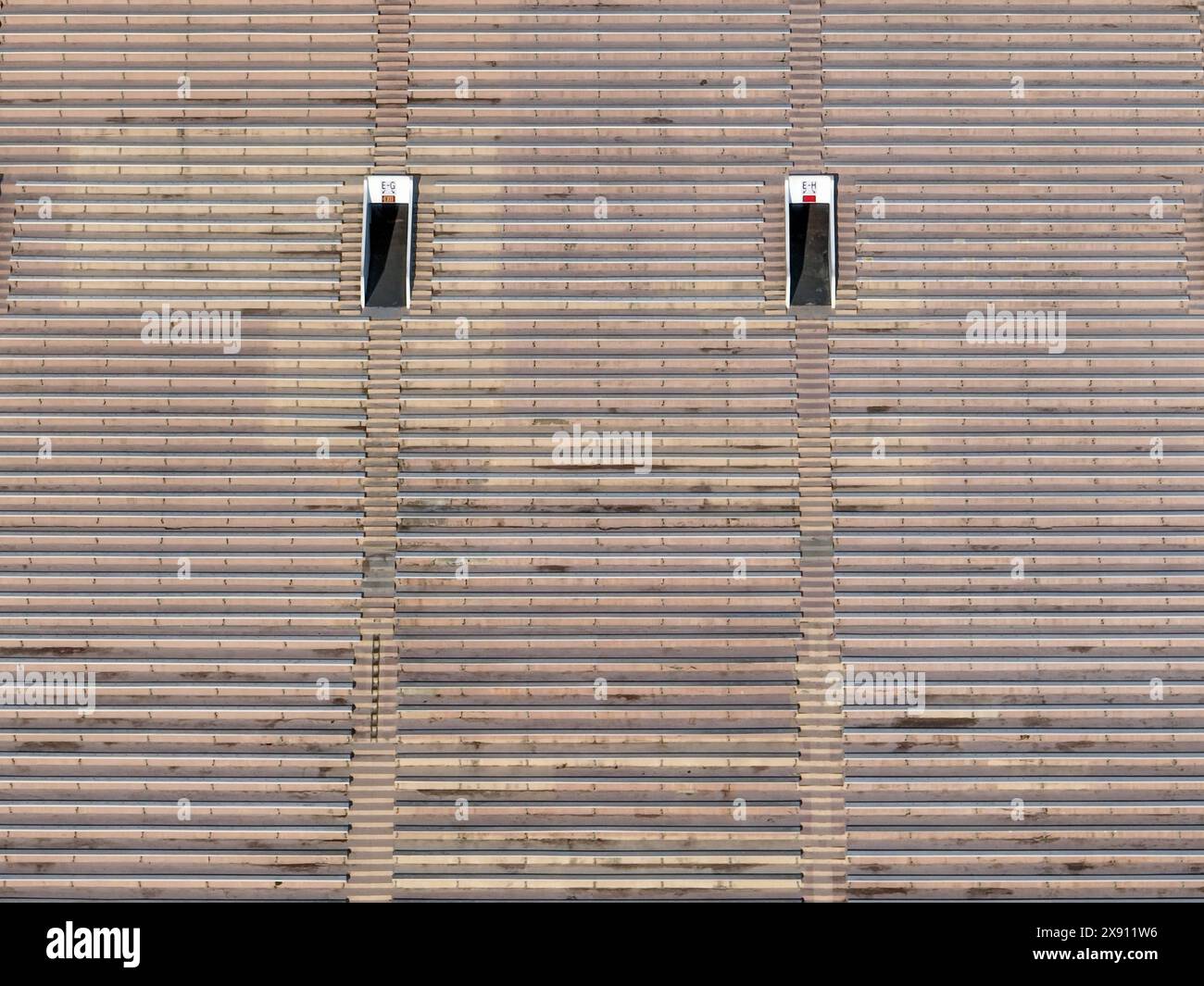 Aerial image of an empty concrete stadium with bench seating and two ...