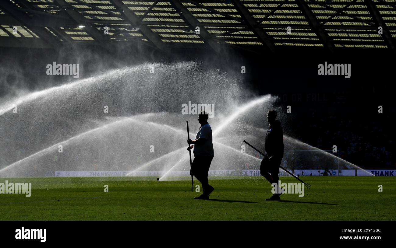A groundsmen are silhouetted as they repair the pitch - Brighton & Hove ...