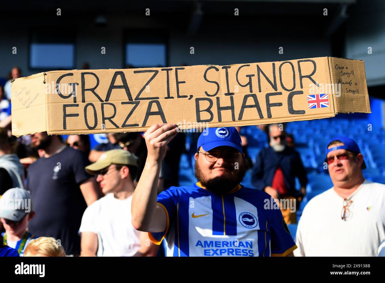 A fan holds up a sign thanking Manager of Brighton and Hove Albion ...