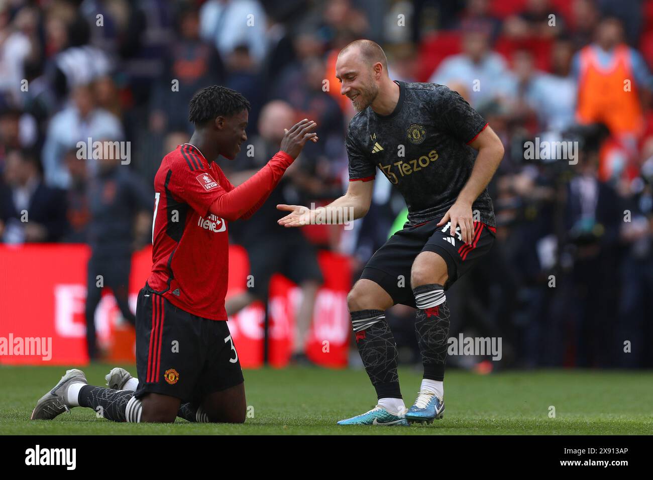 Kobbie Mainoo of Manchester United is congratulated by Christian ...