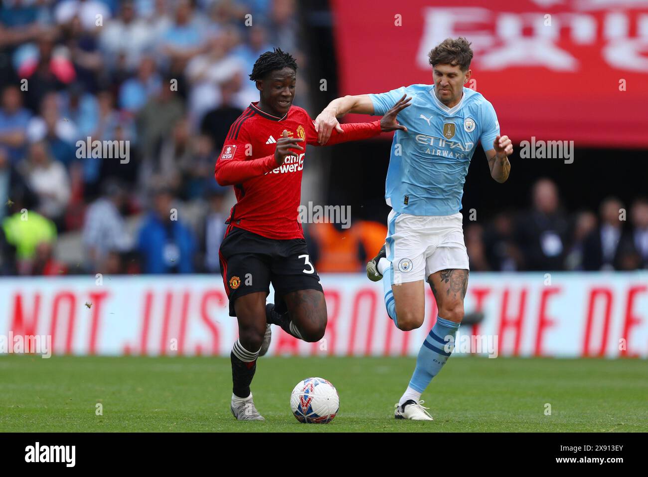 Kobbie Mainoo of Manchester United and John Stones of Manchester City ...