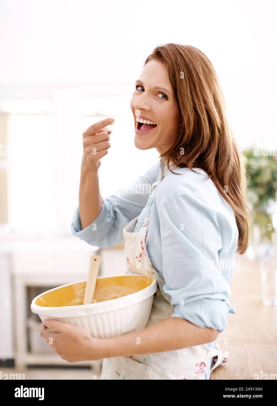 Woman, portrait and baking by tasting batter in kitchen with ...