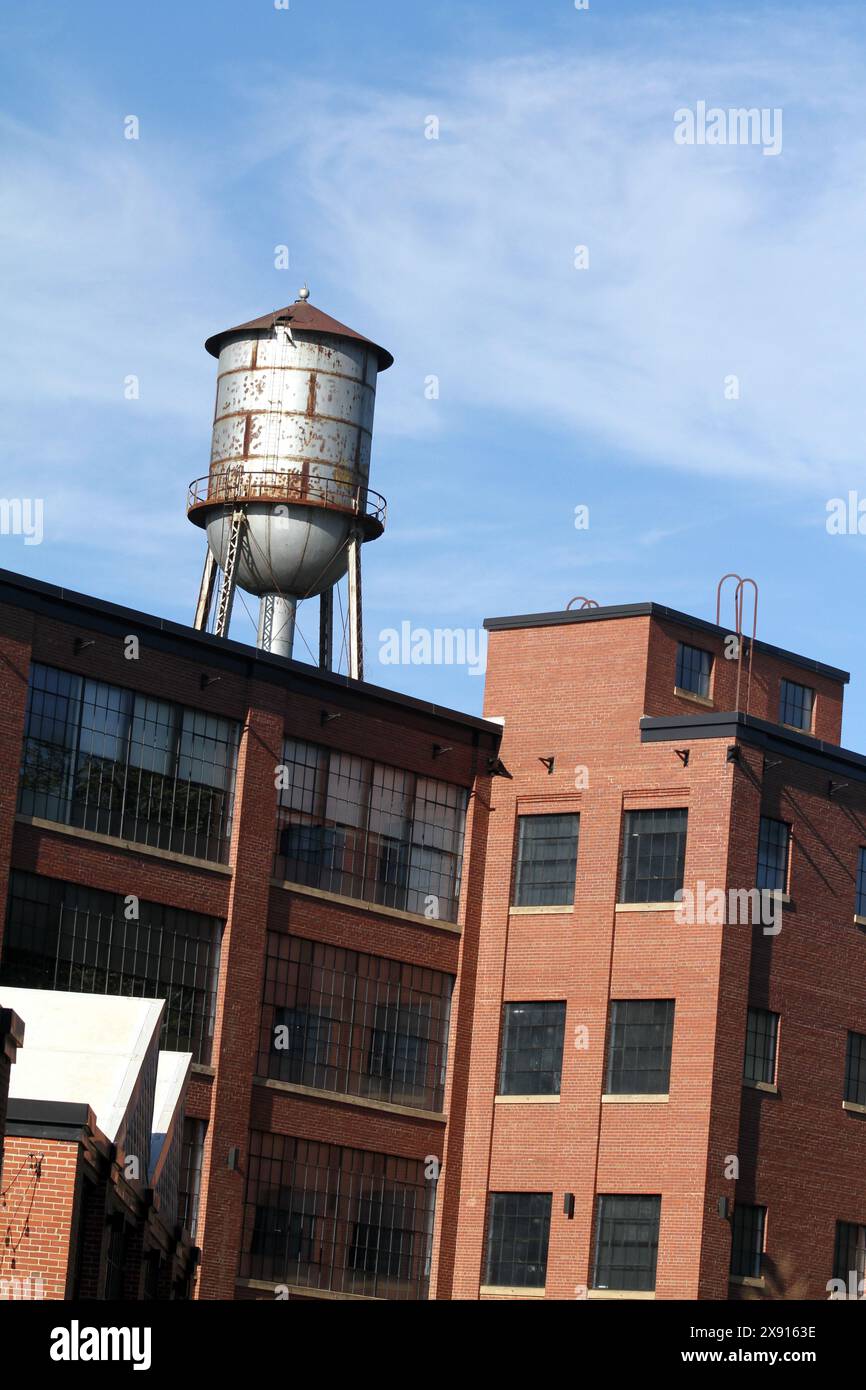 Virginia, U.S.A. Repurposed industrial building with water tank on the ...
