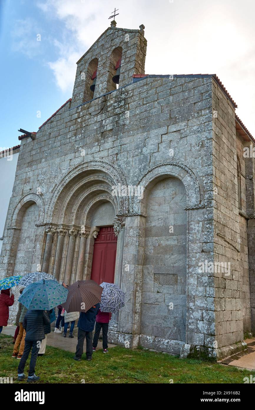 Group of people with umbrellas approach the grand entrance of an old ...