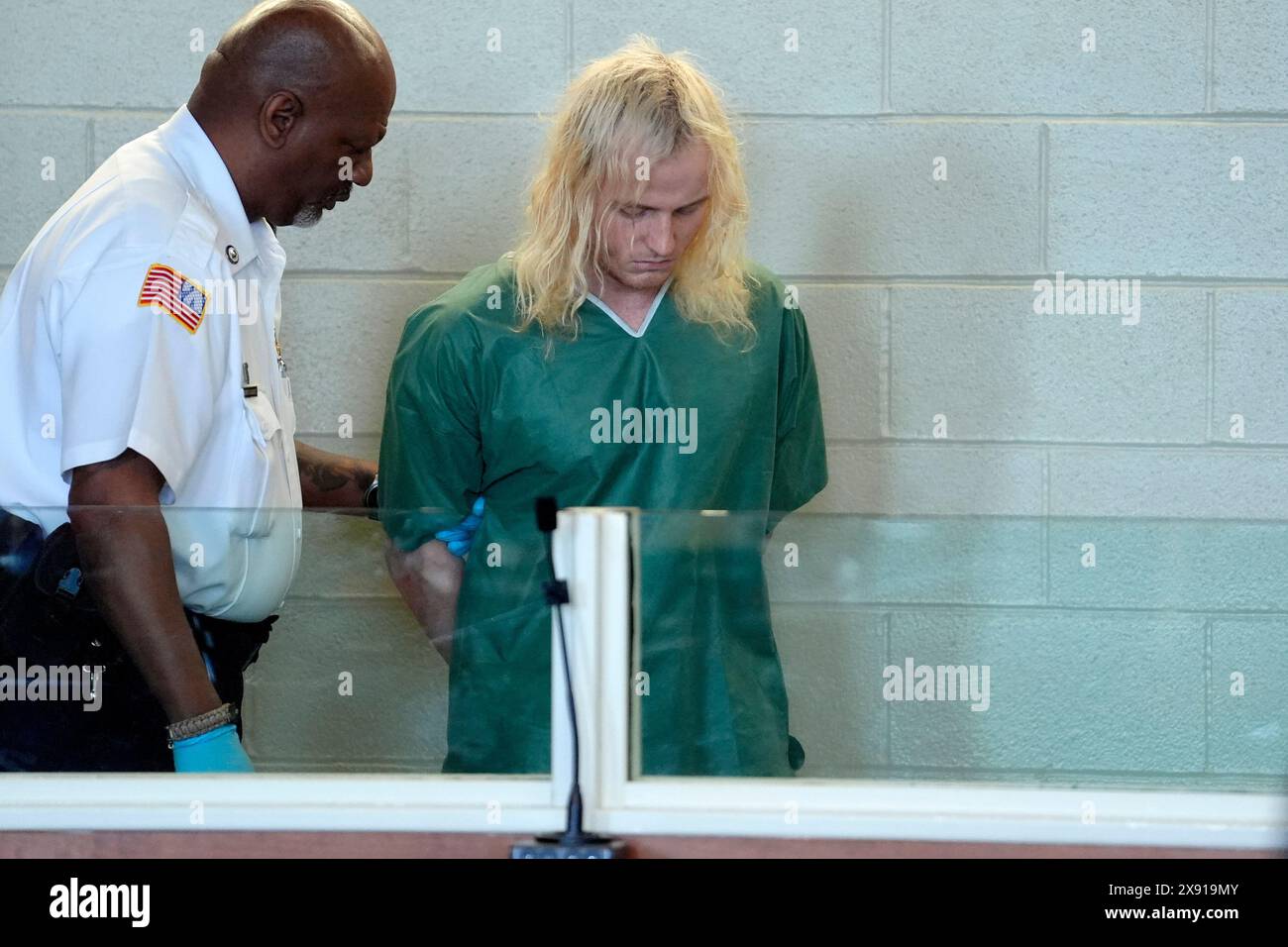 Jared Ravizza, of Chilmark, Mass., right, is escorted by a court ...
