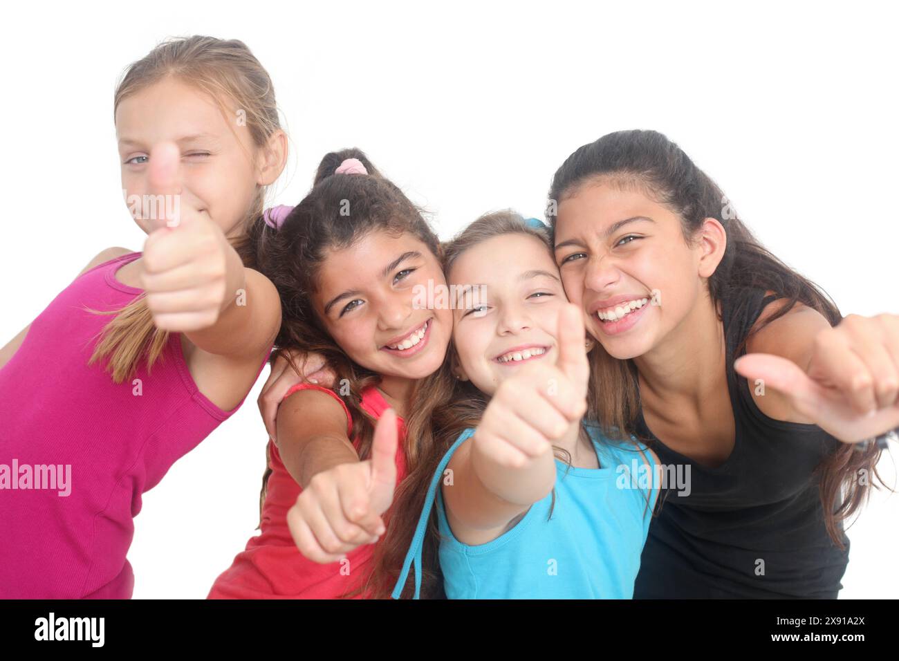 group of cheerful teenage girls showing thumbs up on white background ...