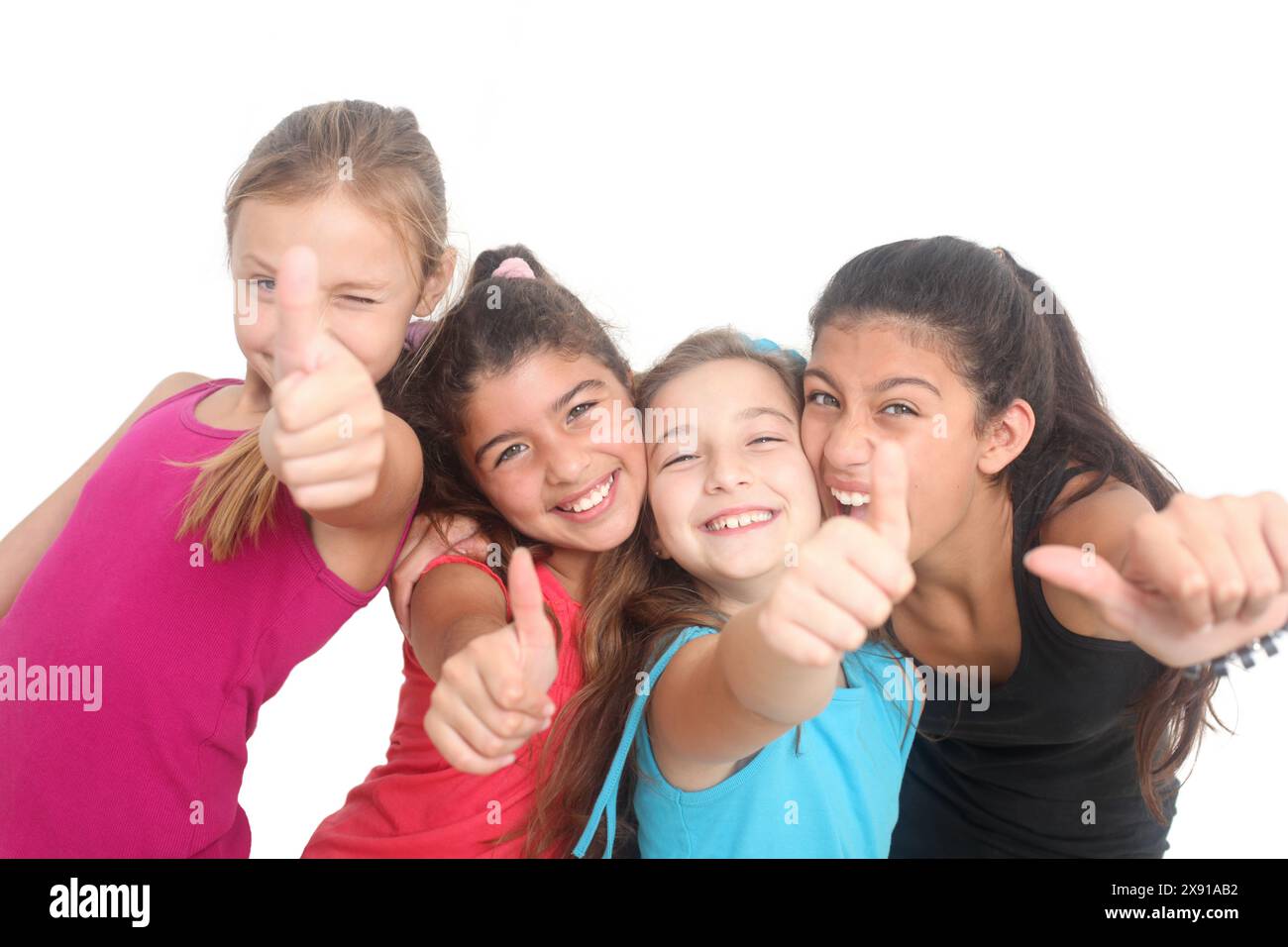 group of cheerful teenage girls showing thumbs up on white background ...