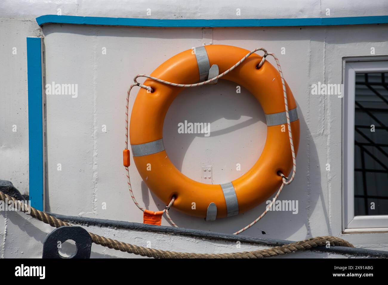 Lifebelt with lifeline on a white background on a ship Stock Photo - Alamy