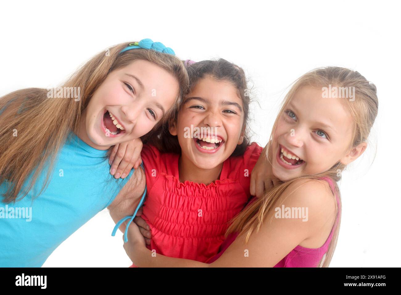 group of cheerful girls in colorful clothes hugging and smiling on ...
