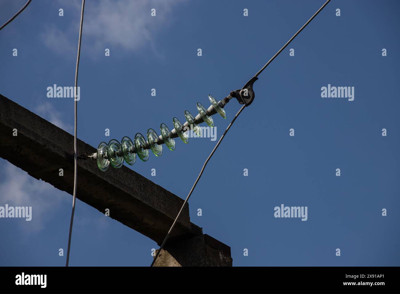 Power lines on background of blue sky close-up. Electric hub on pole ...