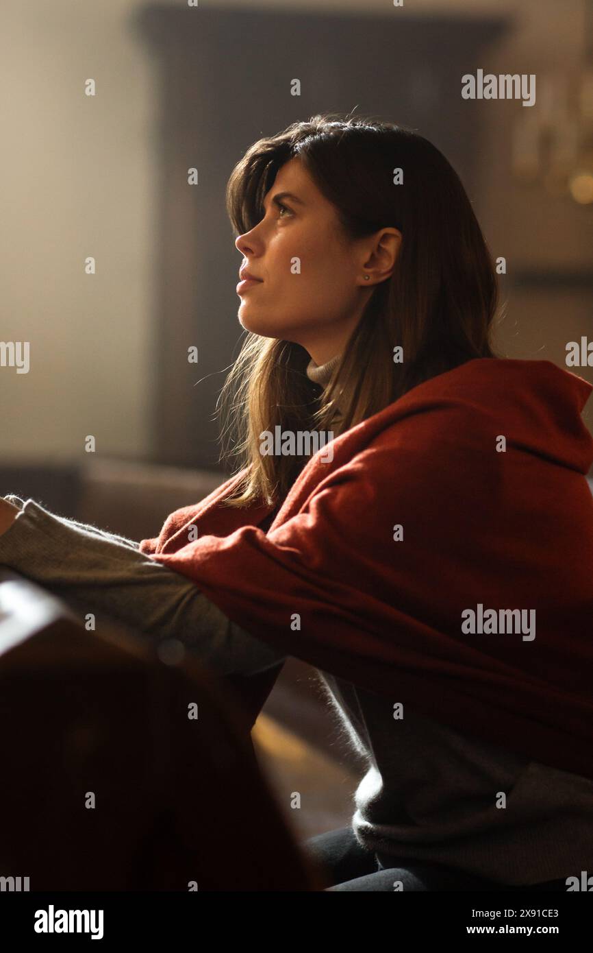 A Devout Christian Woman Sits Piously In a Church, Folding Hands For ...
