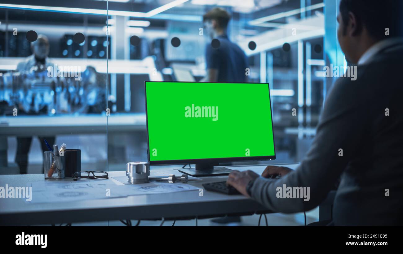 Software Developer Working on Computer with Green Screen Mock Up Display. Scientific Lab ...