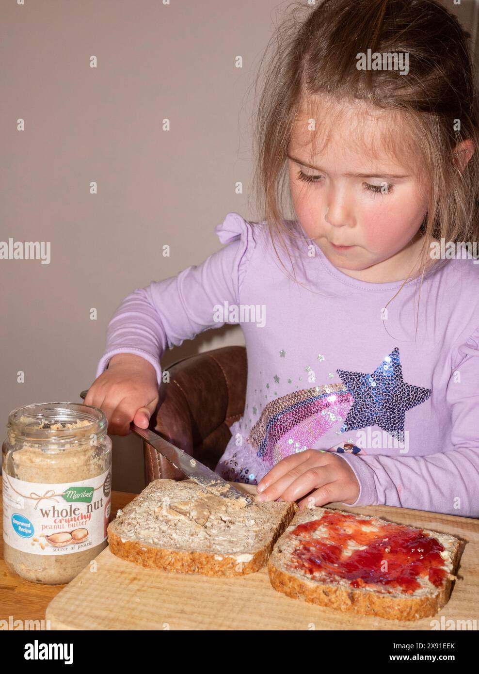 Child making a peanut butter and jam sandwich Stock Photo - Alamy