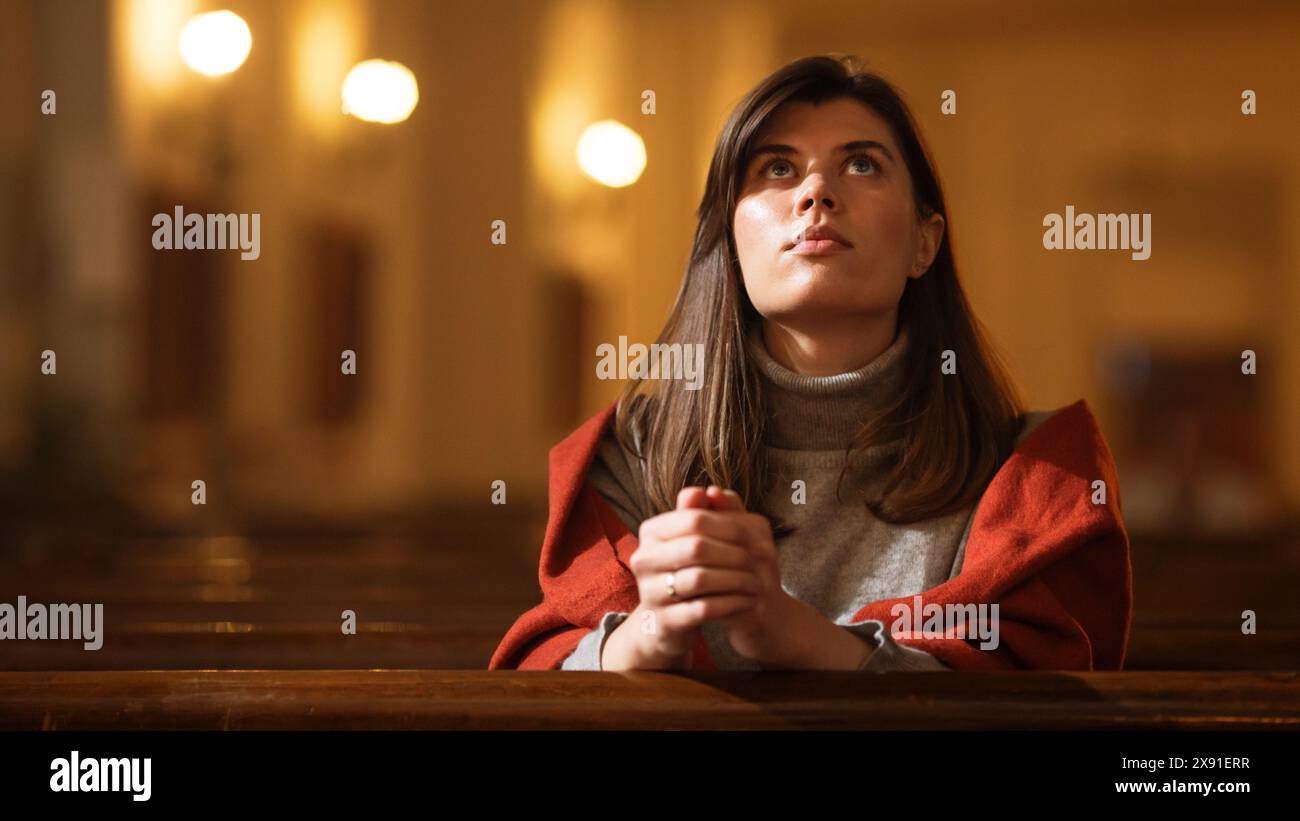 A Devout Christian Woman Sits Piously In a Church, Folding Hands For ...