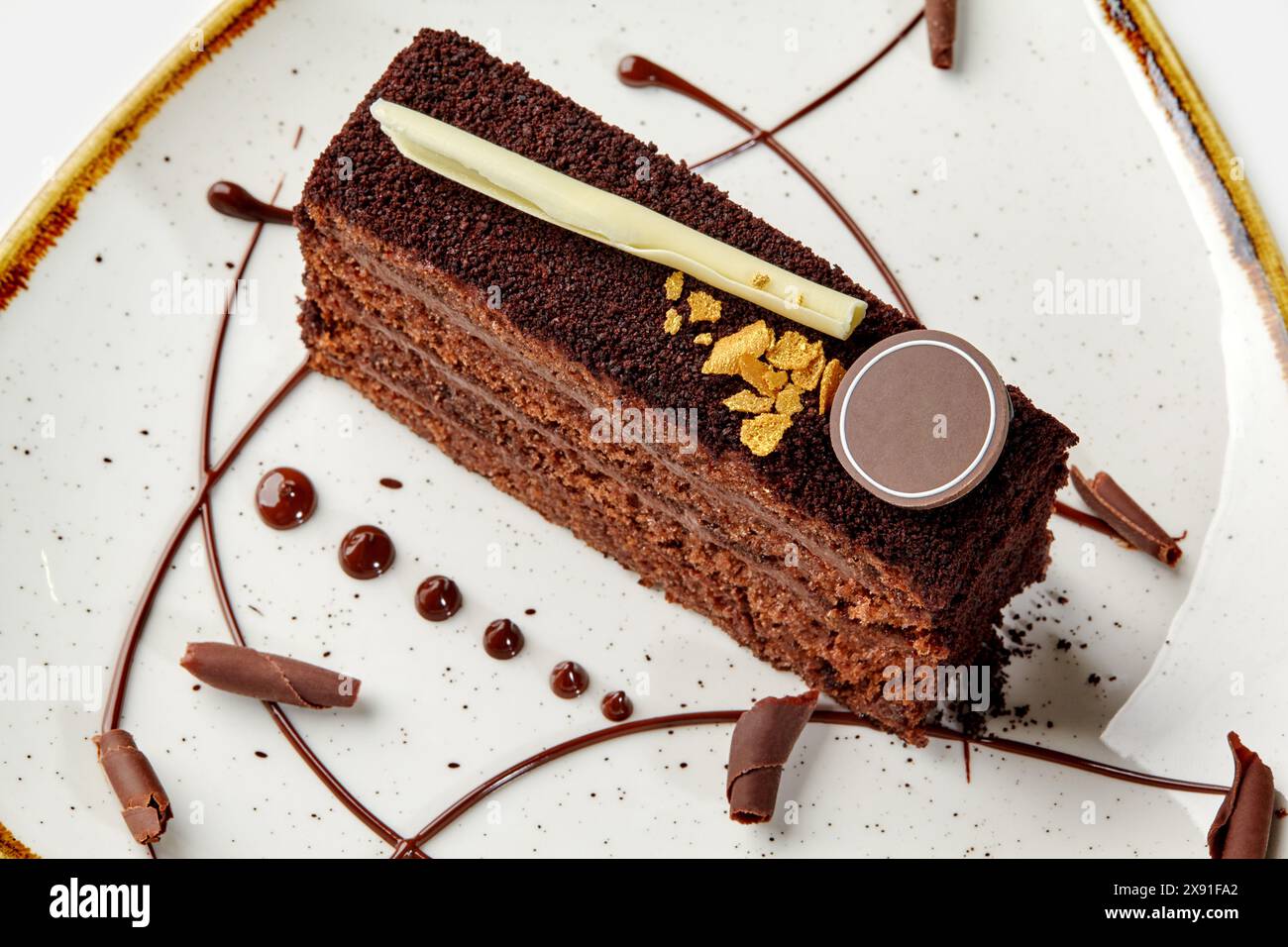 Chocolate sponge pastry with layers of ganache on plate Stock Photo - Alamy