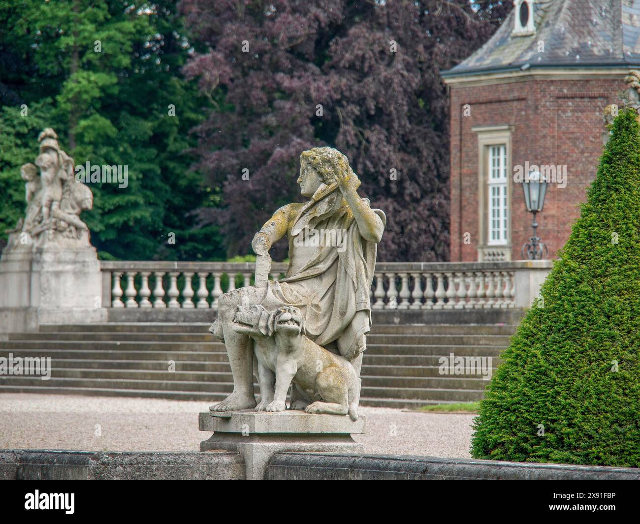 Stone sculpture in front of a castle with stone stairs and balustrades ...