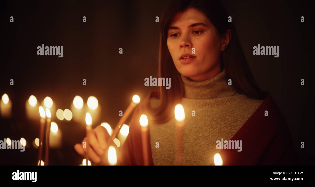 Aesthetic Shot of Young Christian Woman Lighting a Candle in Church ...